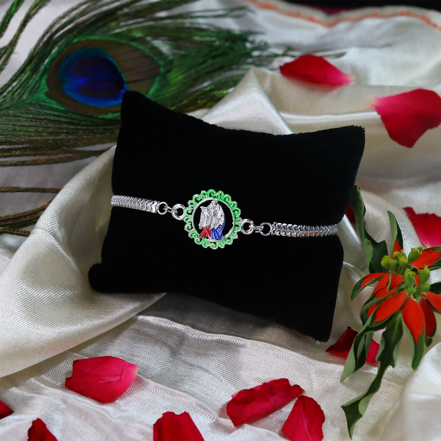 Silver Chain Rakhi with Radha Krishna Motif and Green Enamel Border